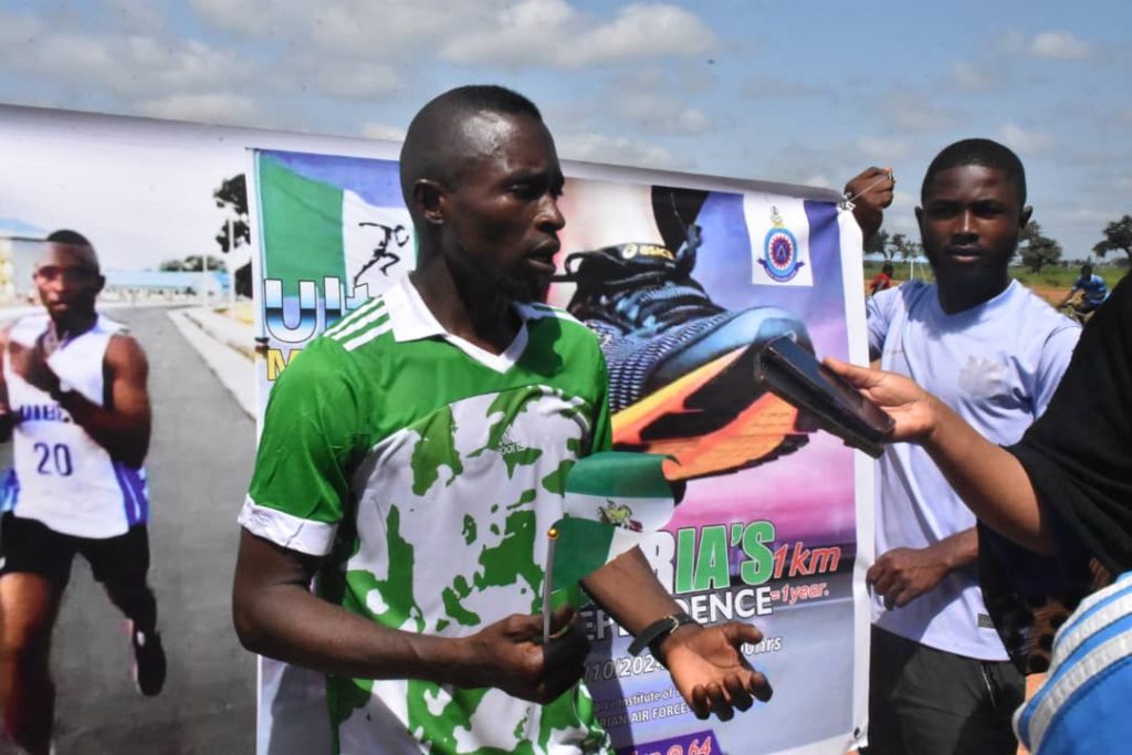 AFIT STUDENT DISPLAYS PATRIOTISM; MARKS INDEPENDENCE WITH 64KM RACE ...